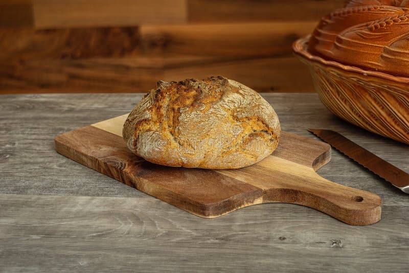 Rustic Wholemeal Rye Bread on Wooden Board with Bread Knife and Bread ...
