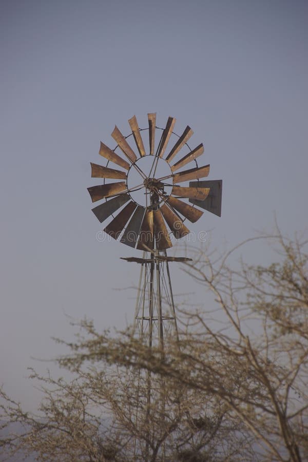 Rustic Windmill and Sailboats Against a Tranquil Coastal Backdrop Stock ...
