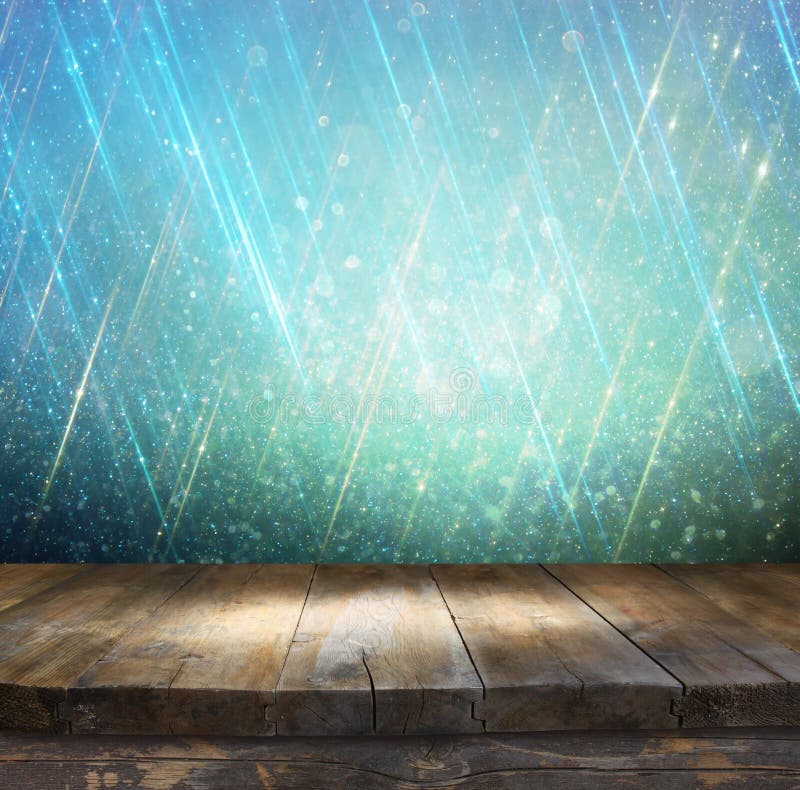 Rustic Wood Table in Front of Glitter Silver, Blue, and Gold Bokeh ...