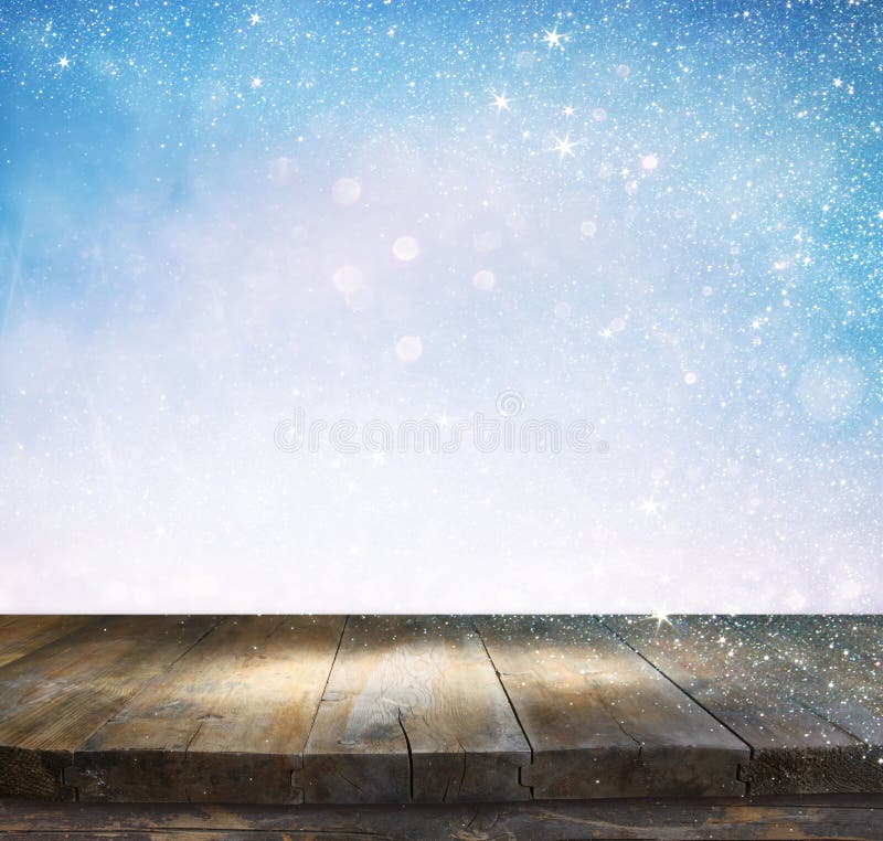 Rustic Wood Table in Front of Glitter Silver, Blue, and Gold Bokeh ...