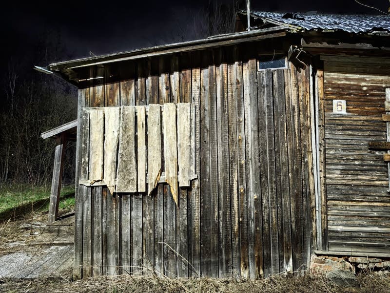 Rustic Wooden Cabin with Peeling Boards at Night in a Secluded Forest ...