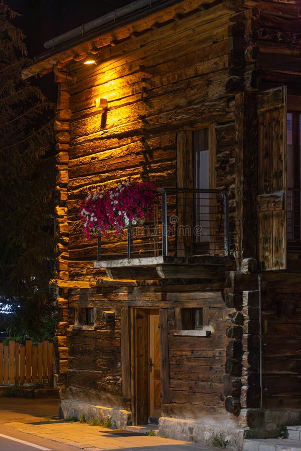 Rustic Wooden Cottage at Night Enhanced by Warm Balcony Lighting Stock ...