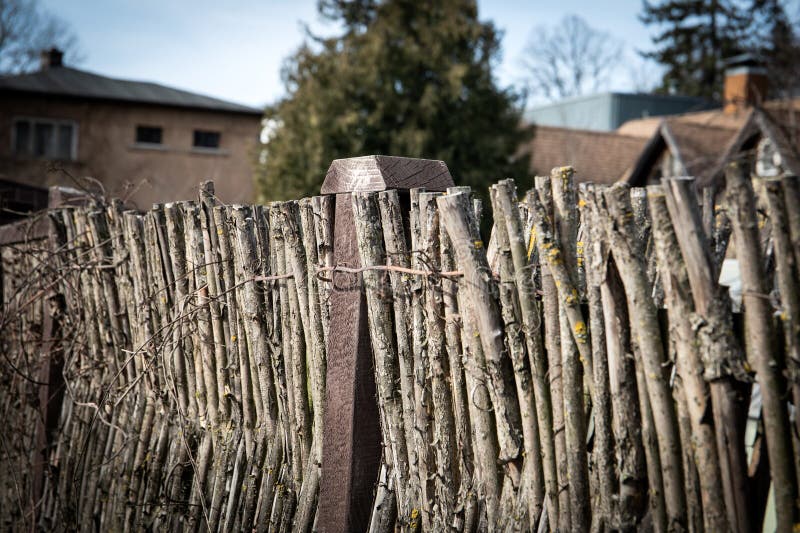 Rustic Wooden Fence with Natural Branches and Village Background Stock ...