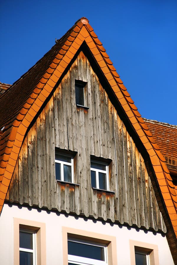 Rustic Wooden Gable with Contrasting Windows and Terracotta Roof Stock ...