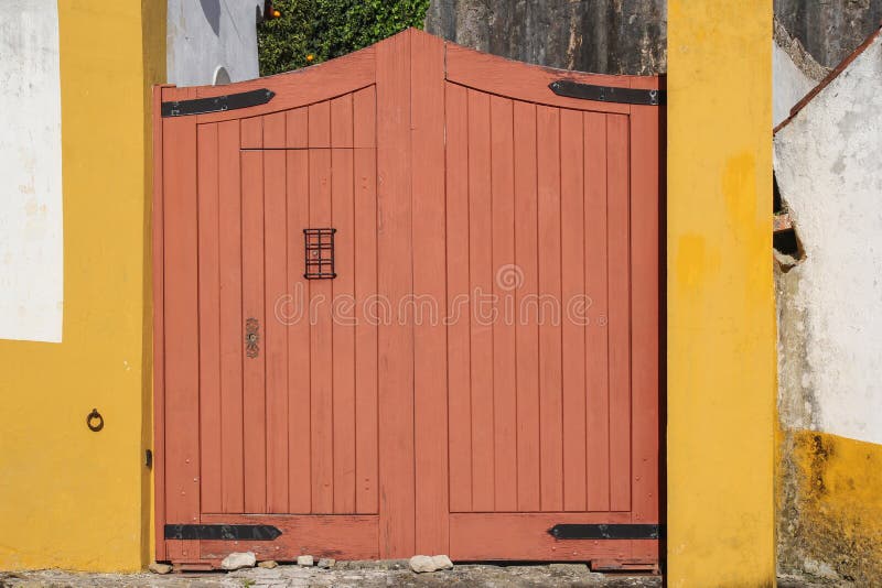 Wooden gate in yellow wall stock image. Image of house - 214860525