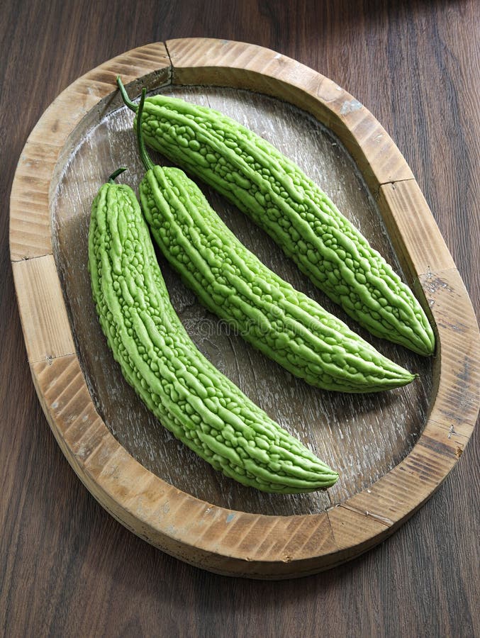Rustic Wooden Plate of Bitter Melons on a Wooden Surface Stock Photo ...