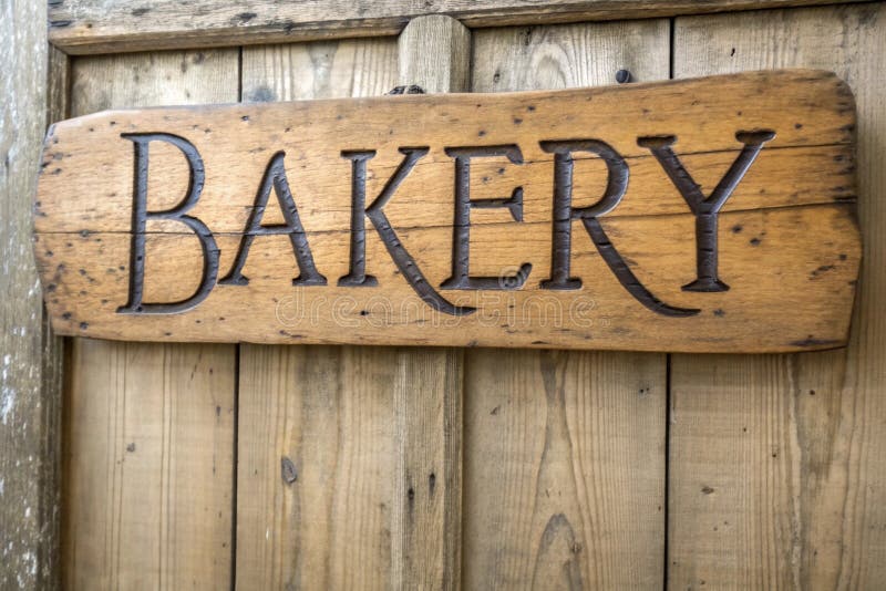 Rustic Wooden Sign with Carved Letters Indicating a Bakery - Generated ...