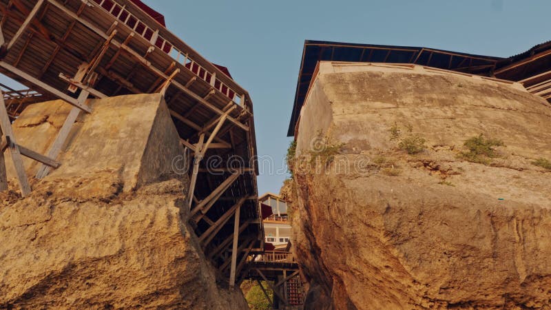 Rustic Wooden Structures between Rocky Cliffs Stock Video - Video of ...