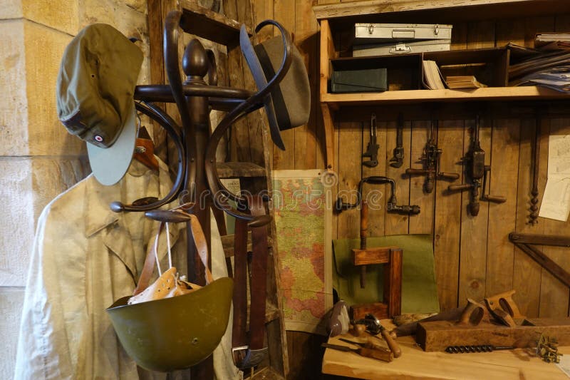 Rustic Workshop Scene with Military Cap and Helmet on a Coat Rack ...
