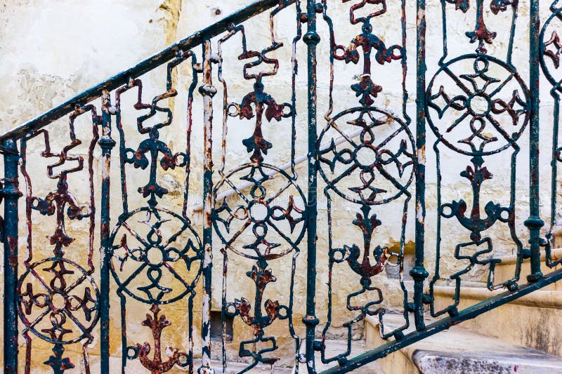 Rustic Wrought Iron Railing with Ornate Patterned Details in an Outdoor ...