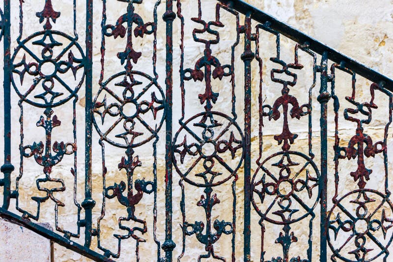 Rustic Wrought Iron Railing with Ornate Patterned Details in an Outdoor ...