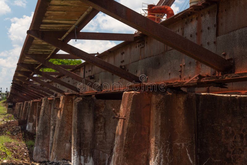Rusting Low Train Trestle with Outrigger Walkway Outside a Derelict ...