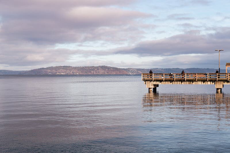 People Fishing Off Wood Dock in Puget Sound at Sunset Stock Image ...