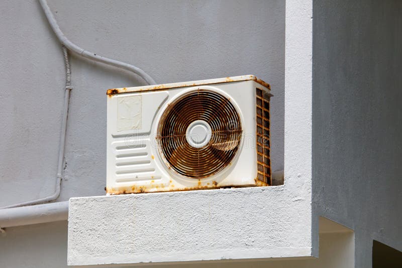 A Rusty Air Conditioner Unit is Sitting on a White Wall Stock Image ...