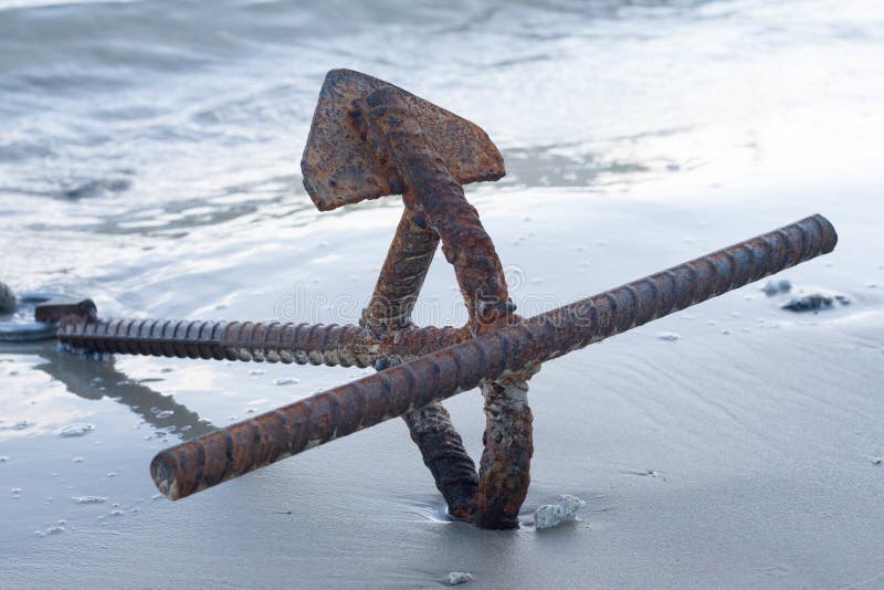 Rusty anchor on the beach stock image. Image of strength - 45674563