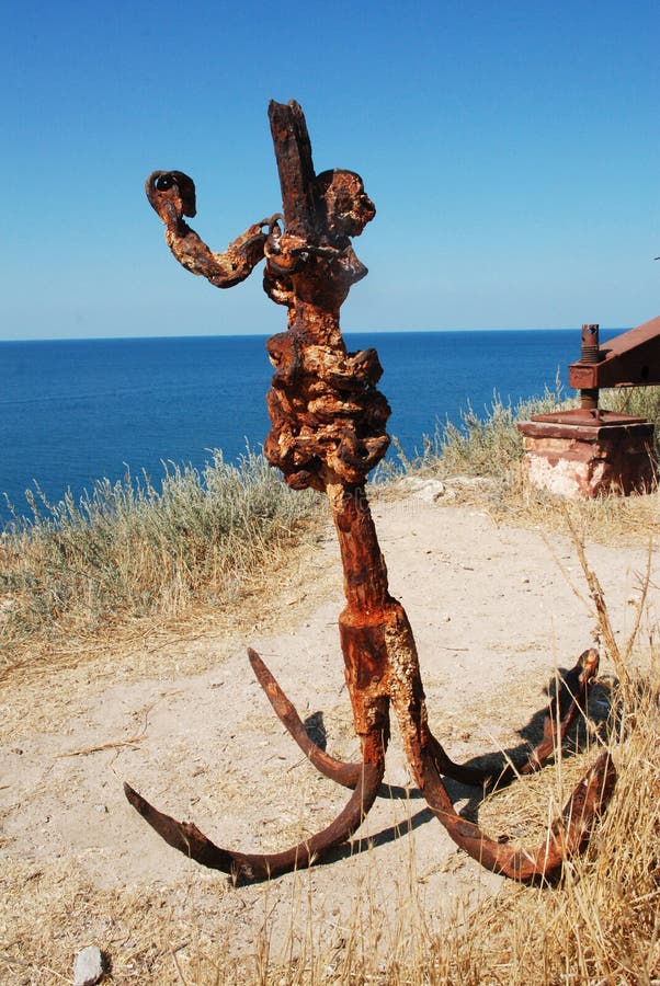 Rusty anchor on the coast stock image. Image of concept - 67746835