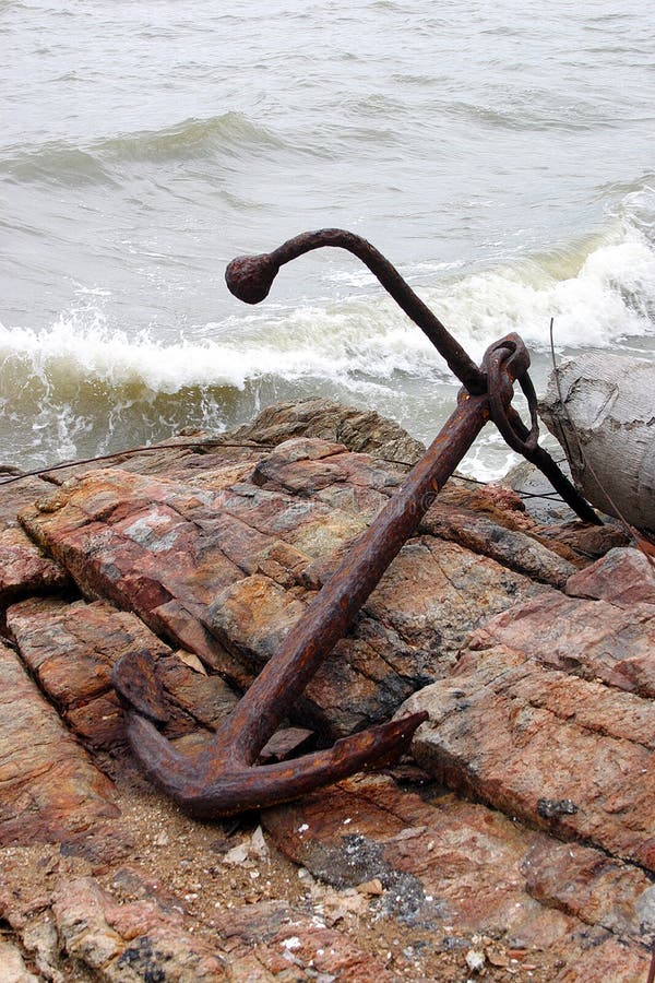 Rusty anchor on rock stock photo. Image of rock, horizontal - 23534628