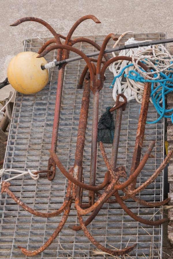 Rusty Anchors Ropes and Buoy on Slatted Frame Stock Photo - Image of ...