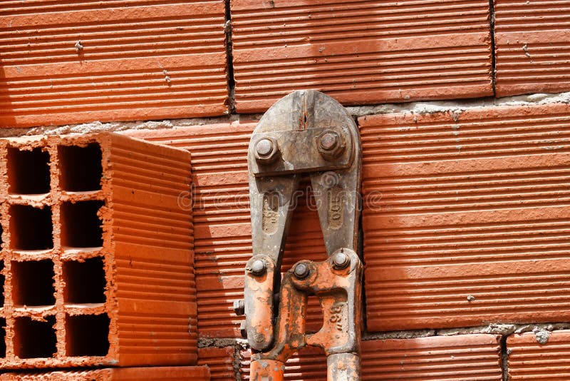 Rusty Bolt Cutter on a Brick Wall Background Stock Photo - Image of ...
