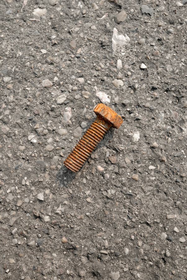 Rusty bolt on the ground stock photo. Image of fastener - 7388262