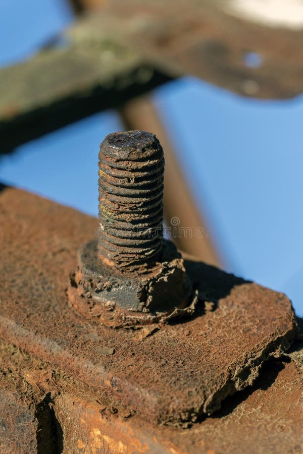 Rusty Bolt on a Weathered Surface Under Clear Blue Sky Showcasing the ...