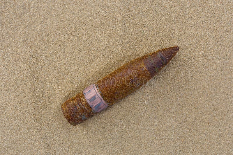 Rusty bullet lie on a sand stock photo. Image of military - 210325922