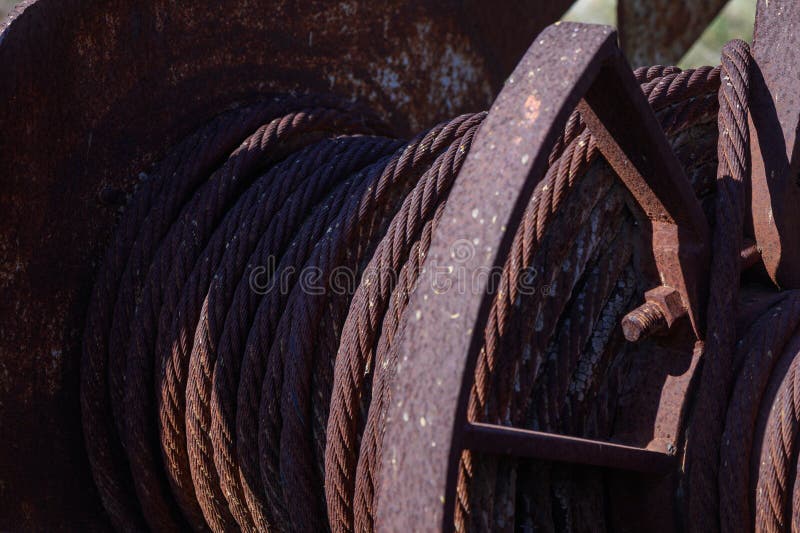 Rusty Cable Reel Resting in the Sunlight with a Backdrop of Serene ...