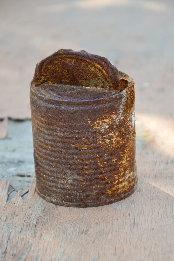 Rusty can on wood plank stock image. Image of steel, brown - 78927053