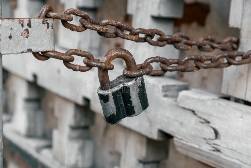 Old Chain Closed with a Rusty Padlock Hangs Above the Concrete Table ...