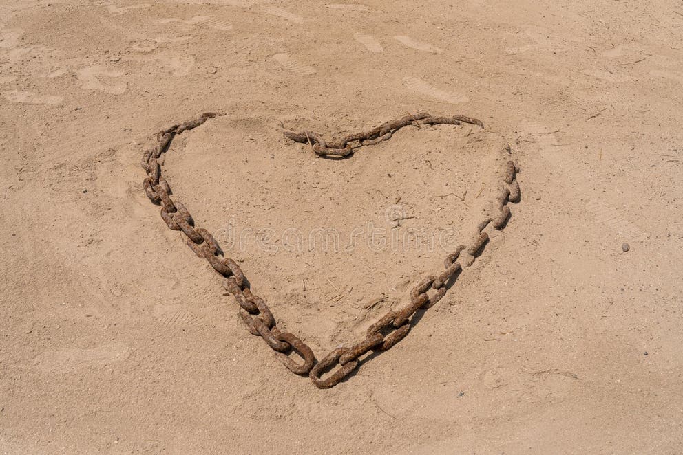 Rusty Chain Formed in Shape of a Heart on a Sandy Beach Stock Photo ...