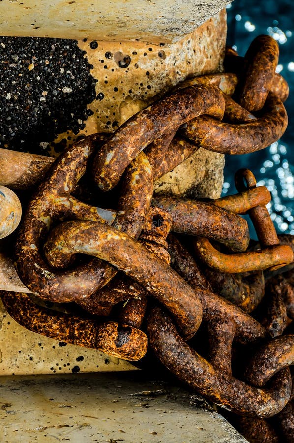 A Rusty Chain is Hanging from a Cement Block Stock Photo - Image of ...