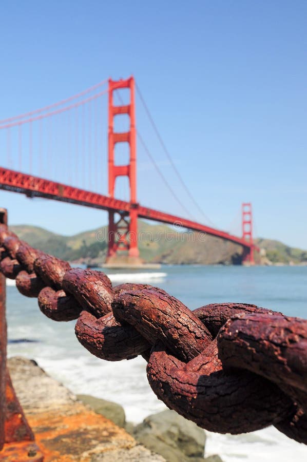 Rusty Chain and Iconic Red Bridge Over Blue Waters Under Clear Sky ...