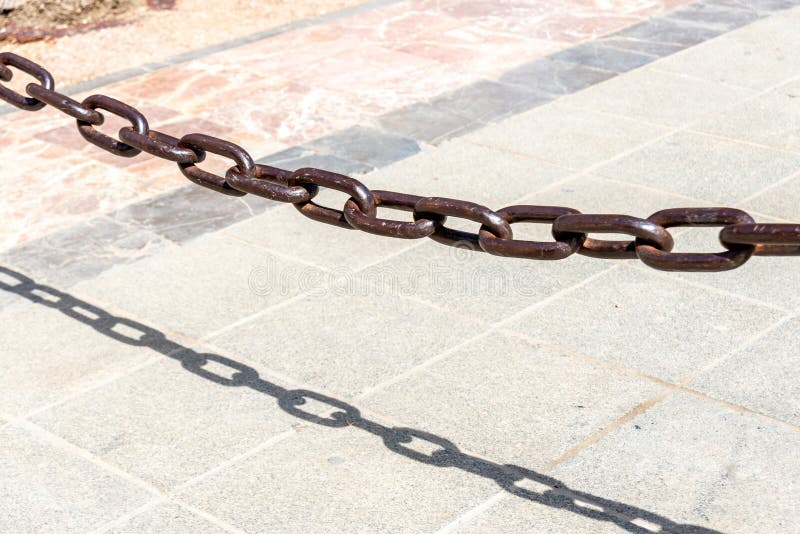 Rusty Chain and Its Shadow on Paved Ground Stock Image - Image of ...