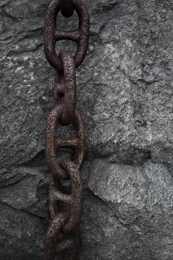 Rusty chain on rock stock photo. Image of stone, strength - 22011536