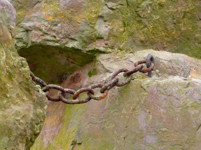Rusty chain on a rock stock photo. Image of rusty, rust - 53595468