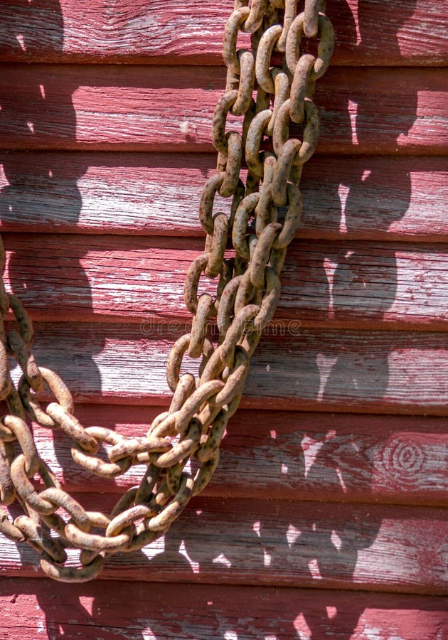 Rusty Chains Against an Old Barnwood Building Stock Image - Image of ...