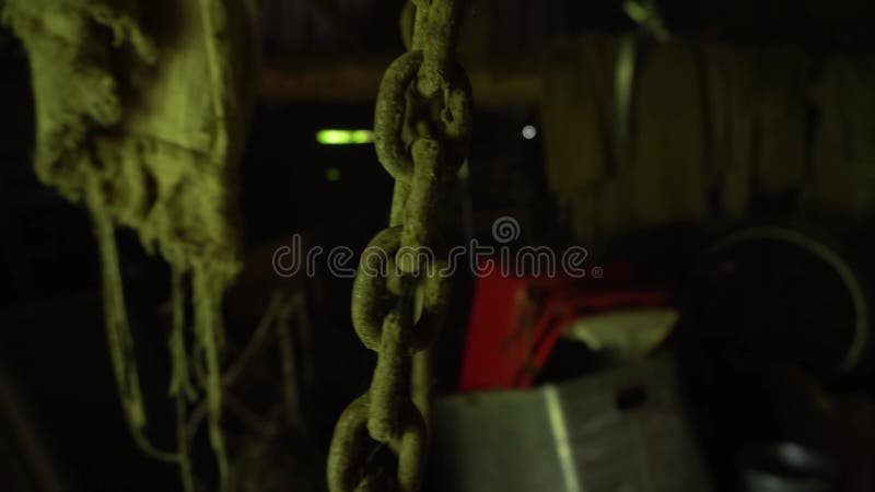 Rusty Chains Hang from the Ceiling and Dangle in an Abandoned Basement ...