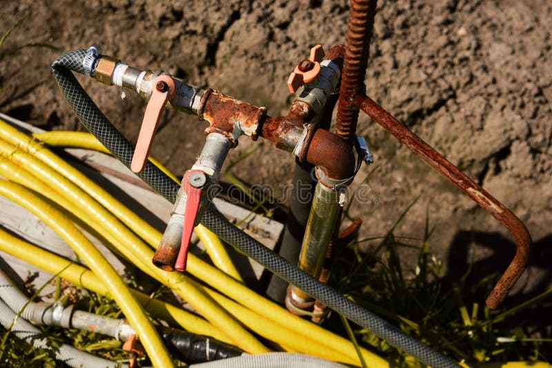 Rusty Crane and Yellow Garden Hose Stock Photo - Image of hose, tube ...