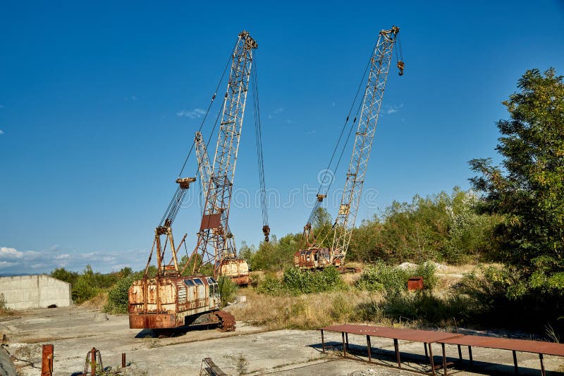 Rusty Cranes in an Abandoned Construction Site. Stock Image - Image of ...
