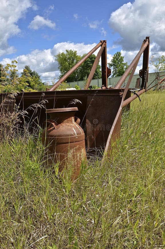 Rusty Cream Can by an Old Front End Loader Stock Photo - Image of ...