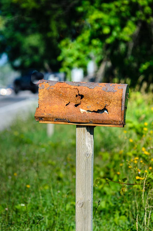 Rusty, Dented Rural Mailbox in Front of Trees Stock Image - Image of ...