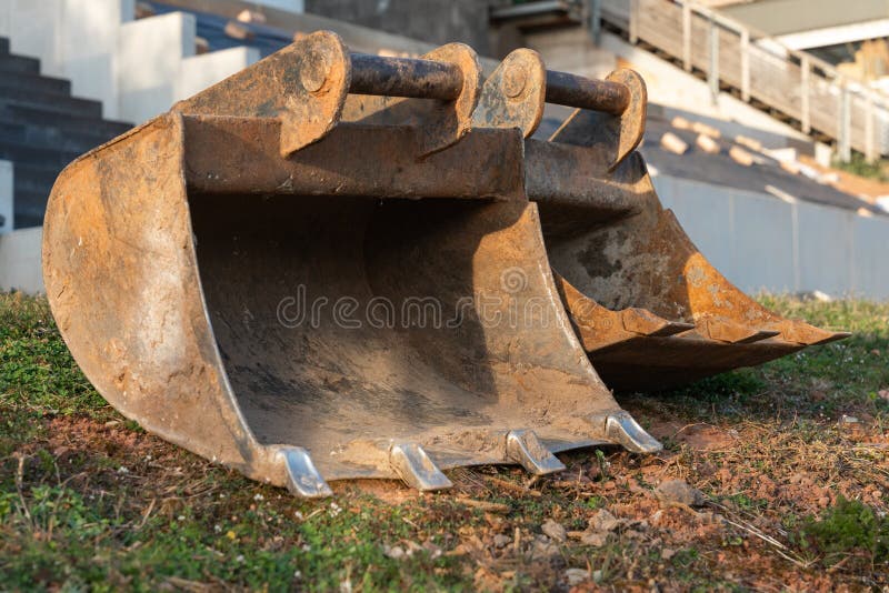 Rusty Digger Attachments on the Ground at a Home Building Site. Mini ...