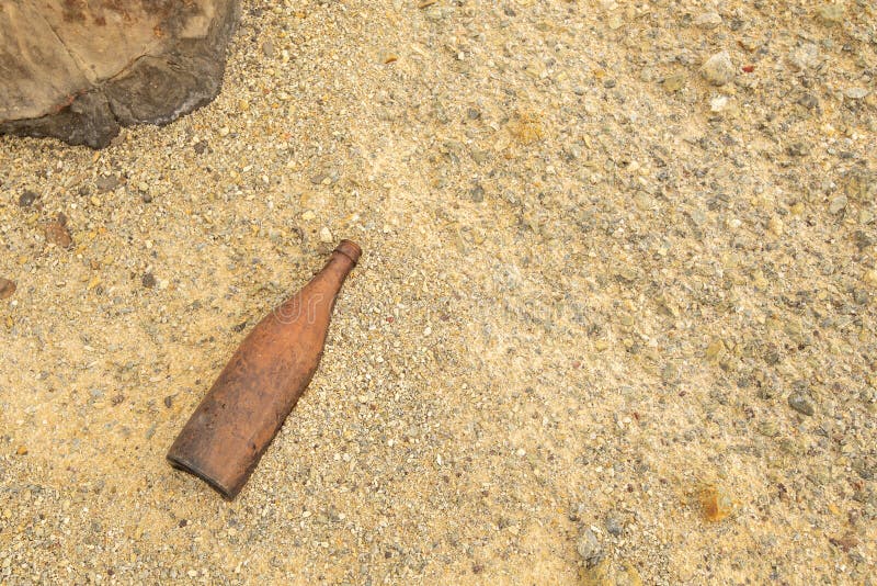Rusty Empty Bottle on a Yellow Contaminated Ground Stock Image - Image ...