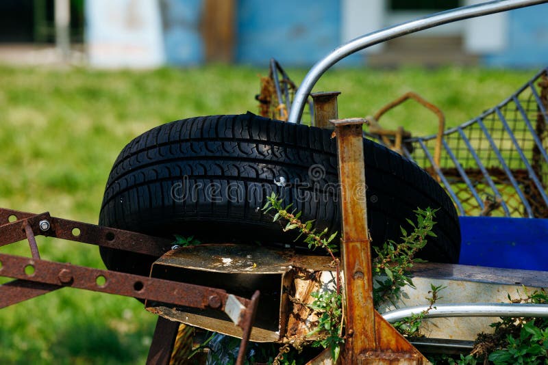 Rusty Farm Equipment with Tire in Field Stock Photo - Image of ...