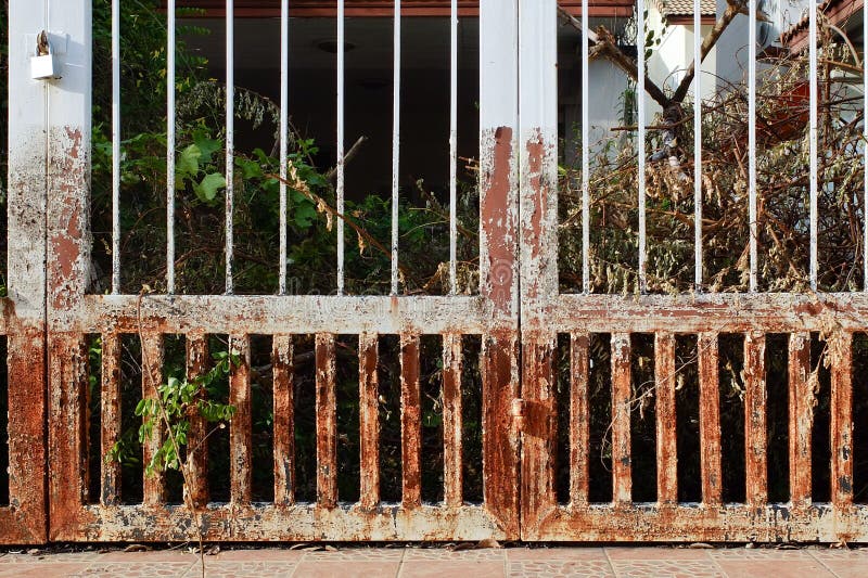 Rusty Fence Made Of Metal Mesh, Square Cells, Against A Background Of ...
