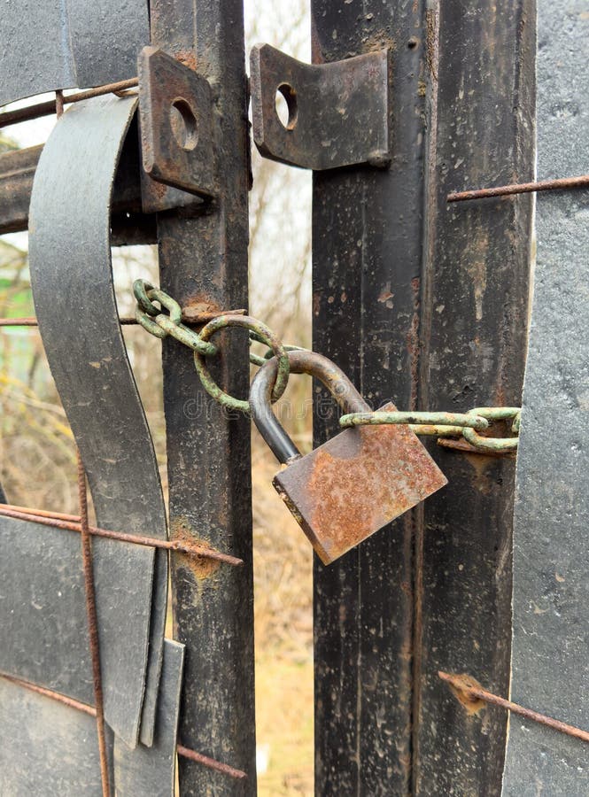 A Rusty Gate with a Chain and a Padlock on it Stock Photo - Image of ...