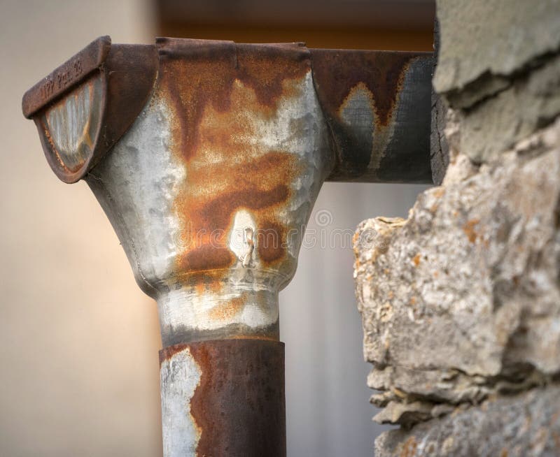 Rusty Gutter Close Up beside a Rough Stone Wall Stock Photo - Image of ...