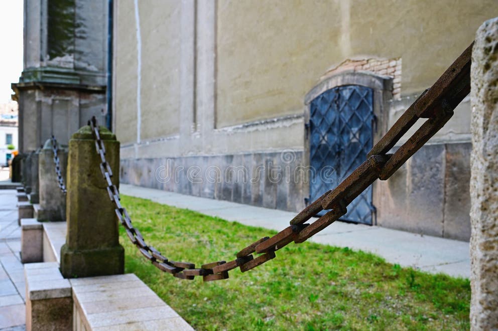 Rusty Heavy Chain Railing of Rectangular Shape Links Hanging from Stone ...