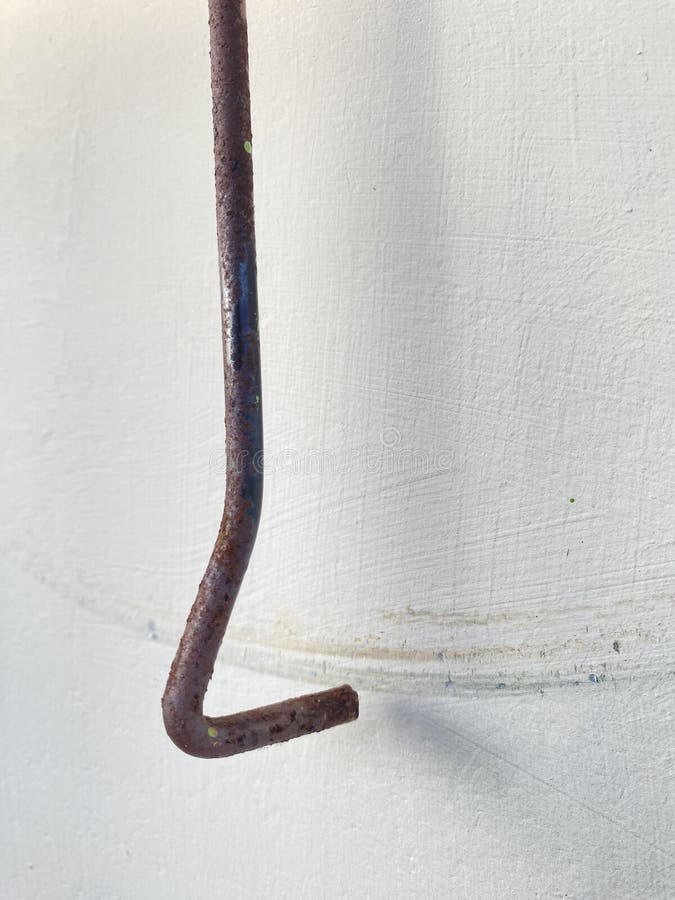 Rusty Hook Attached To a Wall Leaving Rust Marks on the Wall Stock ...
