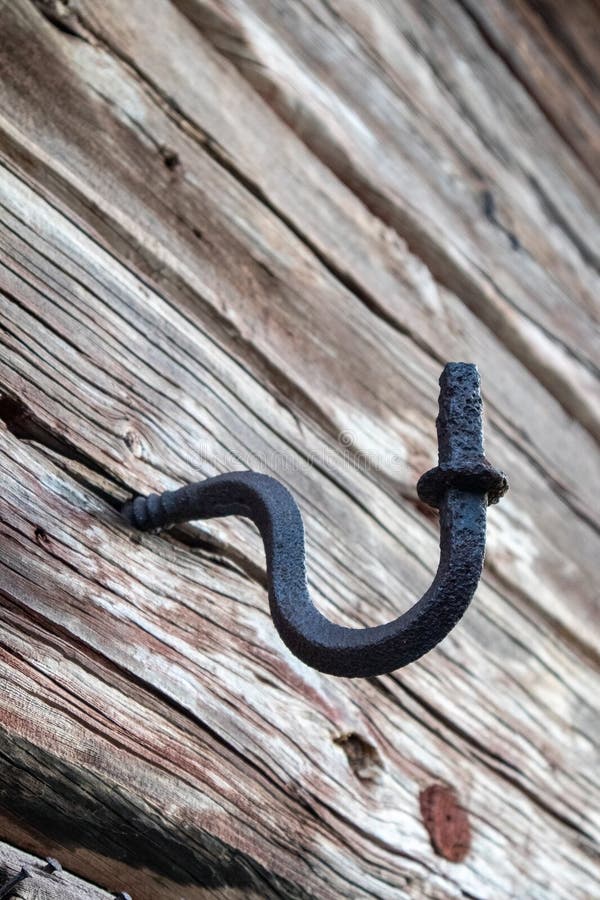 Rusty Hook Stuck in an Old Wooden Wall Outdoors Stock Image - Image of ...